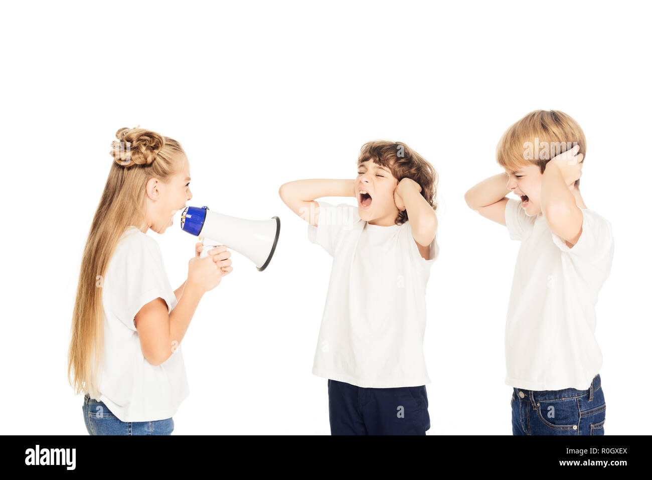child screaming in megaphone, boys covering ears isolated on white ...