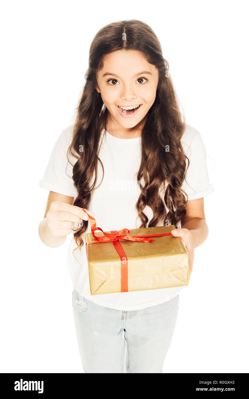 high angle view of excited adorable child holding gift box and looking ...