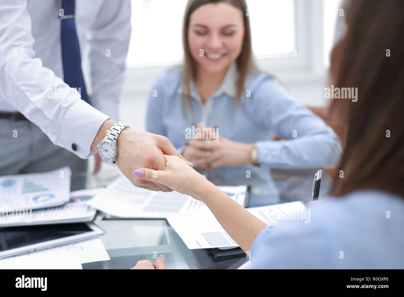 handshake Manager and client over the Desk in the office Stock Photo ...