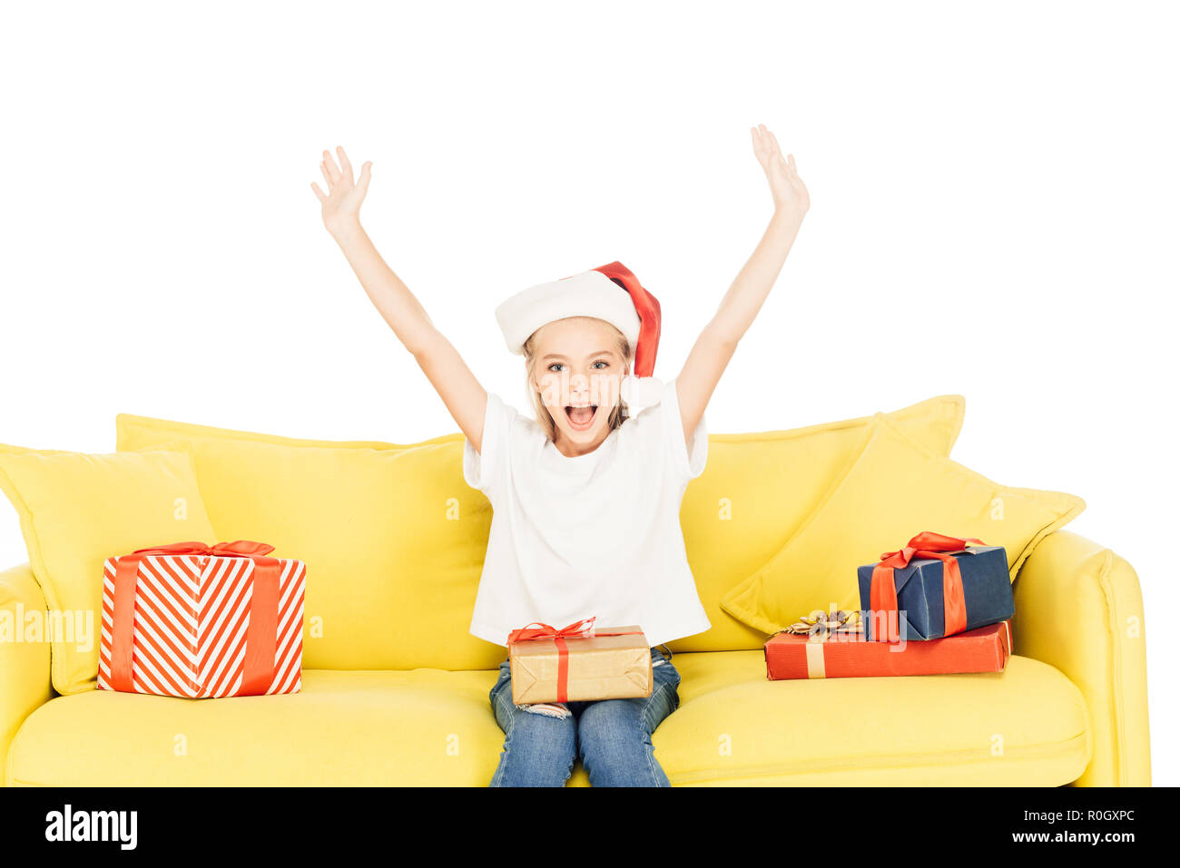 happy adorable child in santa hat screaming with raised hands isolated ...