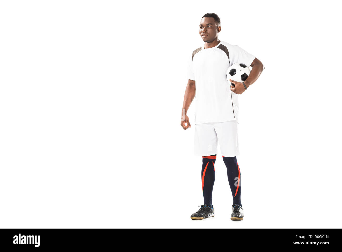 full length view of smiling young african american soccer player ...