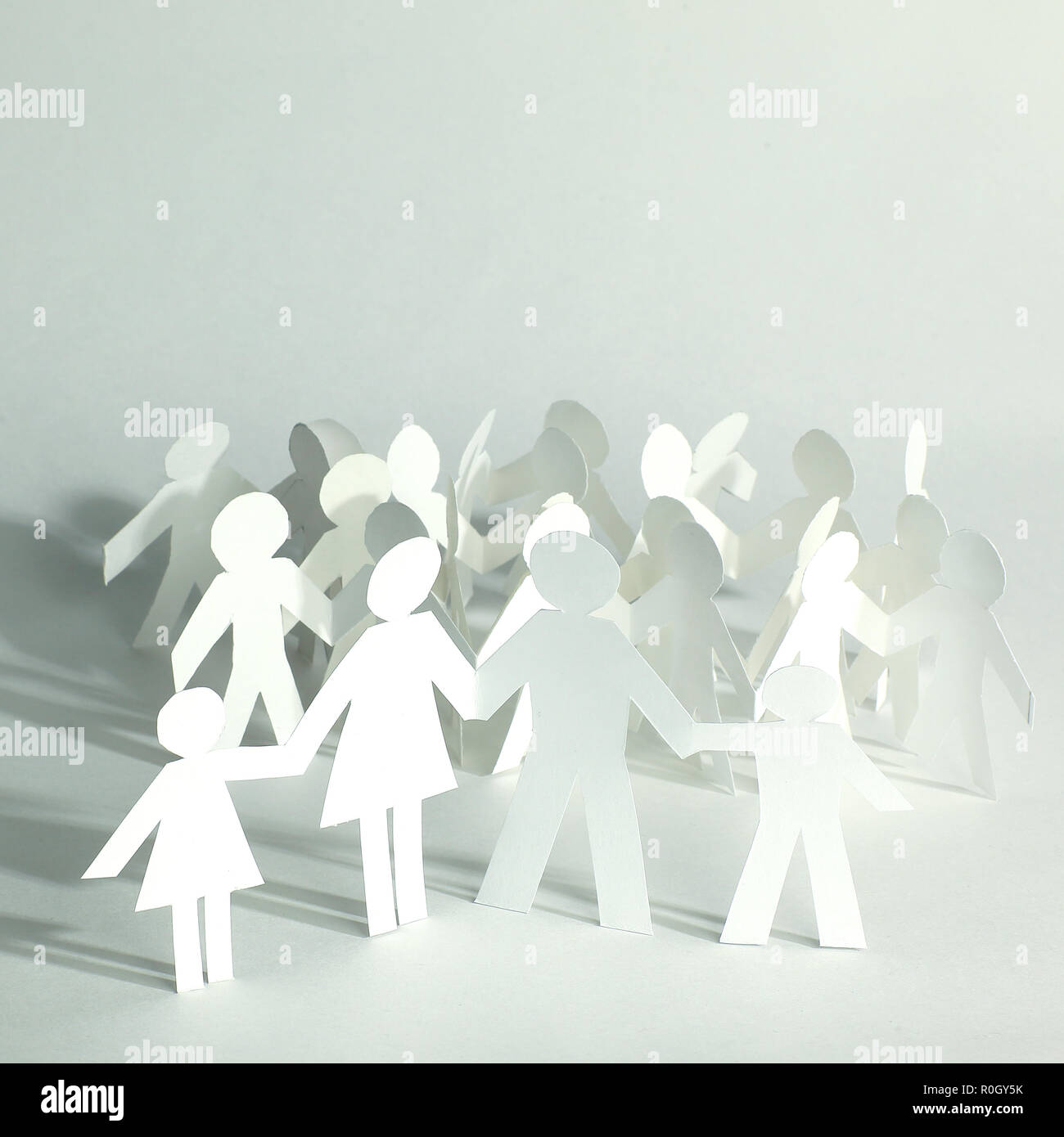 many paper men on the paper background Stock Photo - Alamy