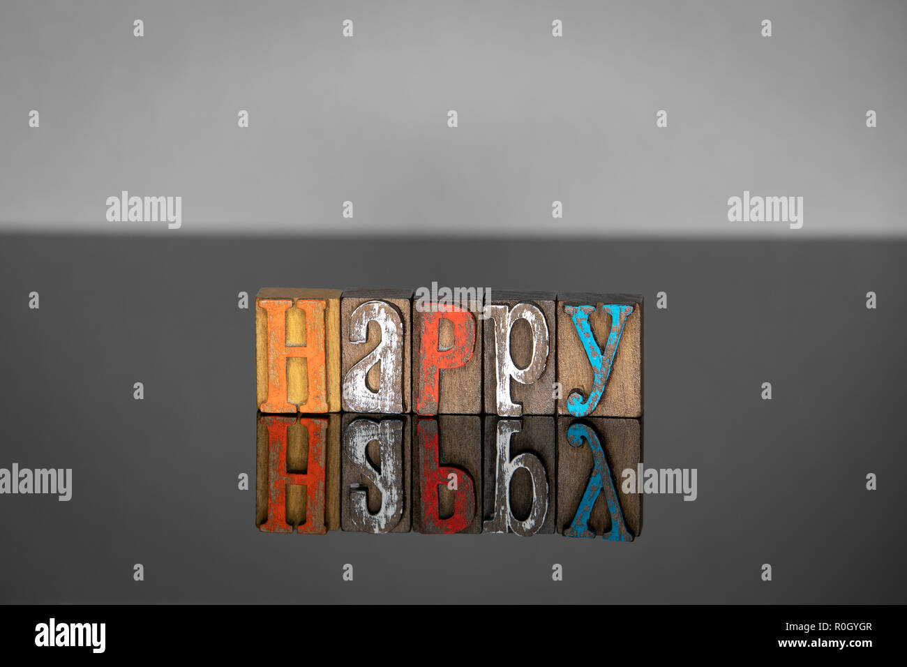 Happy word from colored wooden letters Stock Photo - Alamy