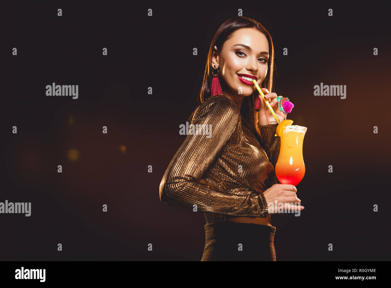 beautiful glamorous girl drinking alcohol cocktail on black Stock Photo ...