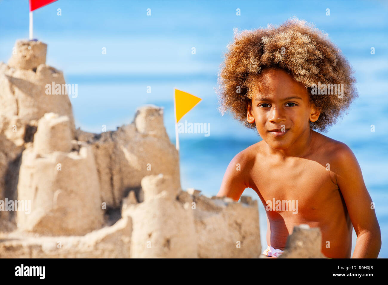 Boy building sandcastle on beach hi-res stock photography and images ...