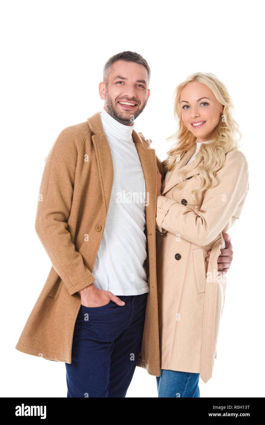 happy beautiful couple posing in beige coats, isolated on white Stock ...