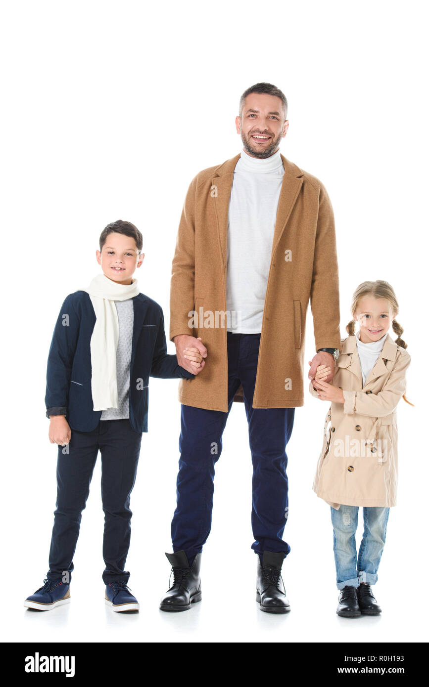 stylish father holding hands with children in autumn outfit, isolated ...