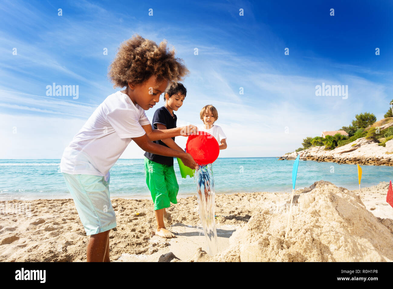 Boy building sandcastle on beach hi-res stock photography and images ...