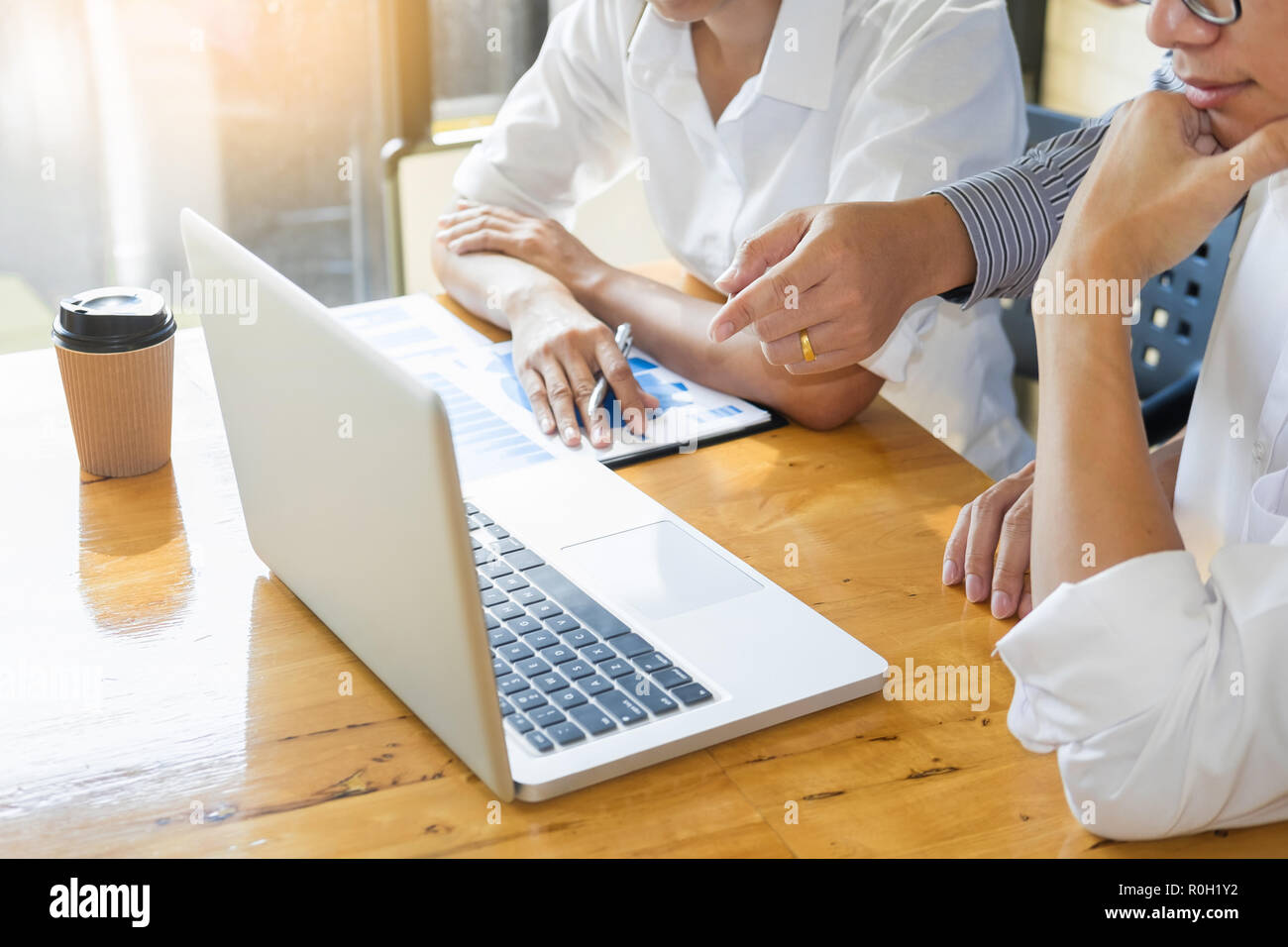 Business Team Meeting Using Laptop Discussion together while going ...