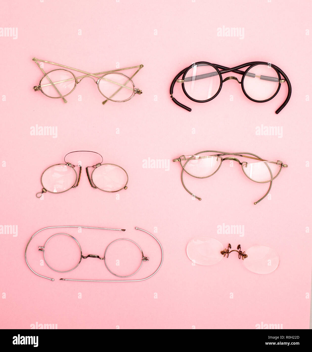Very old eye glasses circa 1900-1940 on pink background top view Stock ...