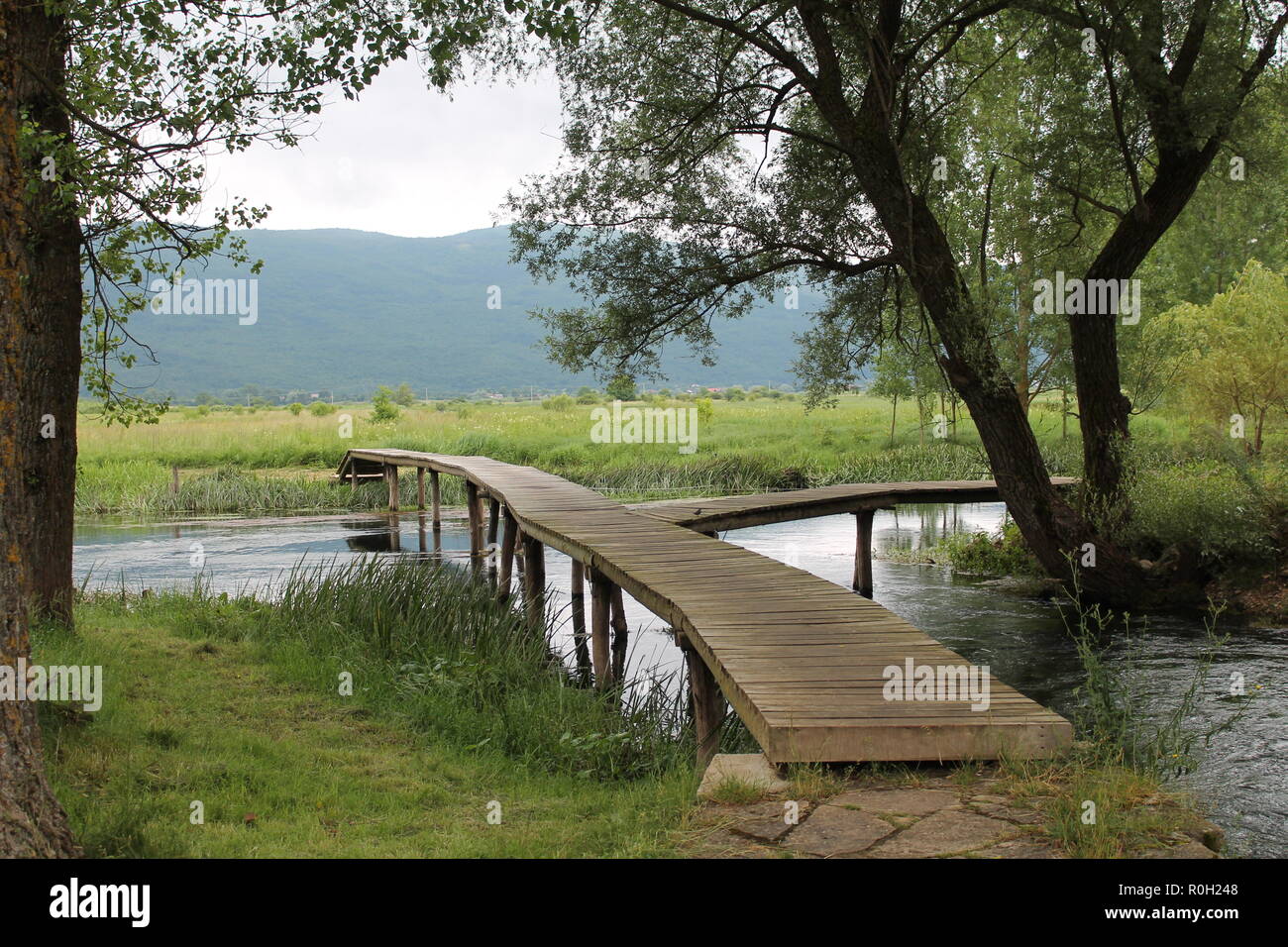 Wooden bridge over river Stock Photo - Alamy