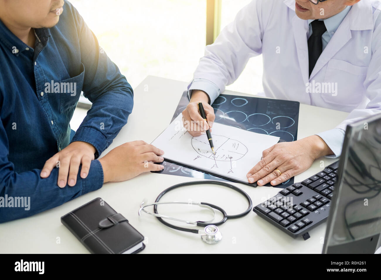 doctor giving a consultation discussing to patient and explaining ...