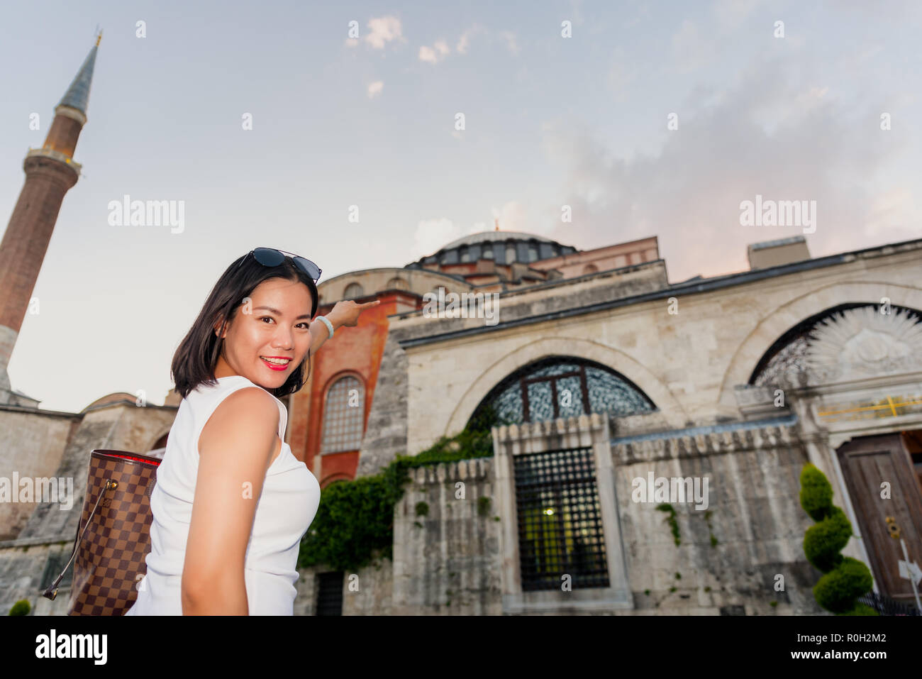 Beautiful woman poses with view of Topkapi Palace on background in ...