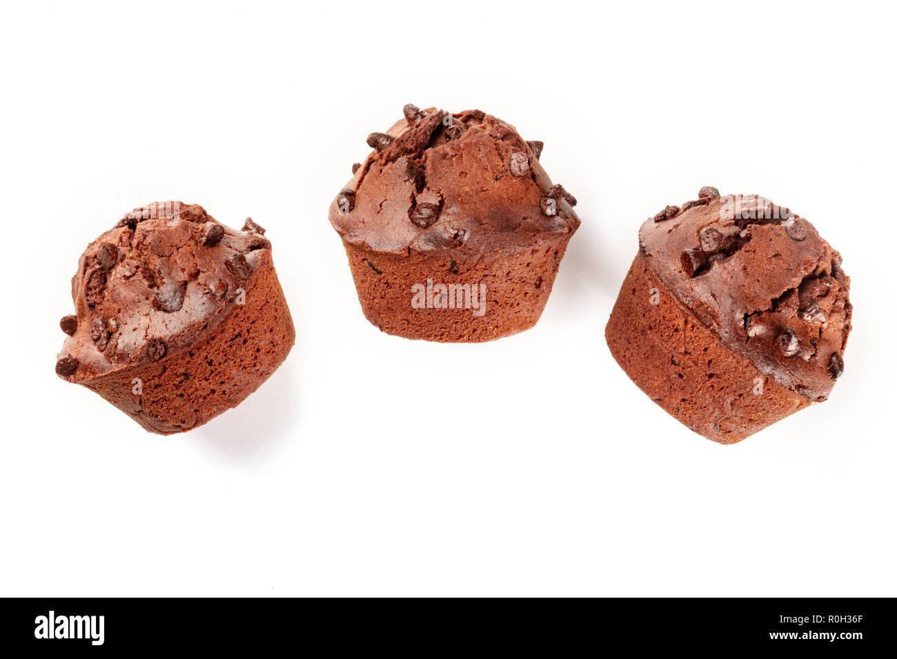 An overhead photo of three chocolate muffins, shot from above on a ...