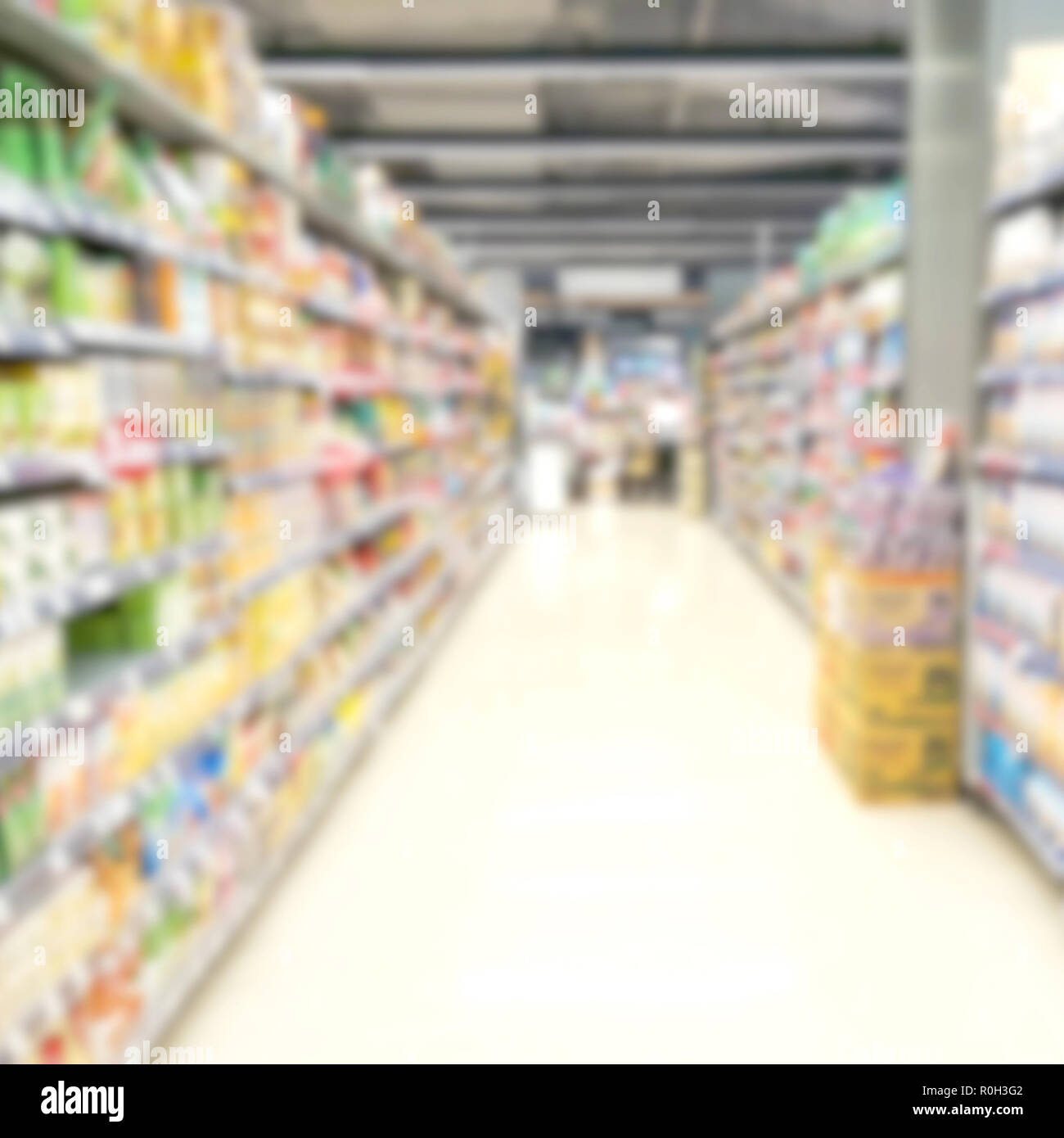 Abstract blur of aisle in supermarket with customers and department ...