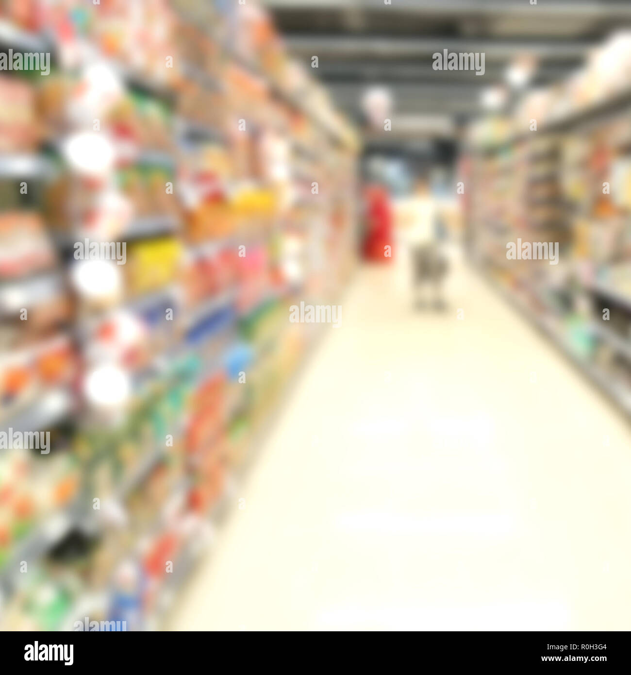 Abstract blur of aisle in supermarket with customers and department ...