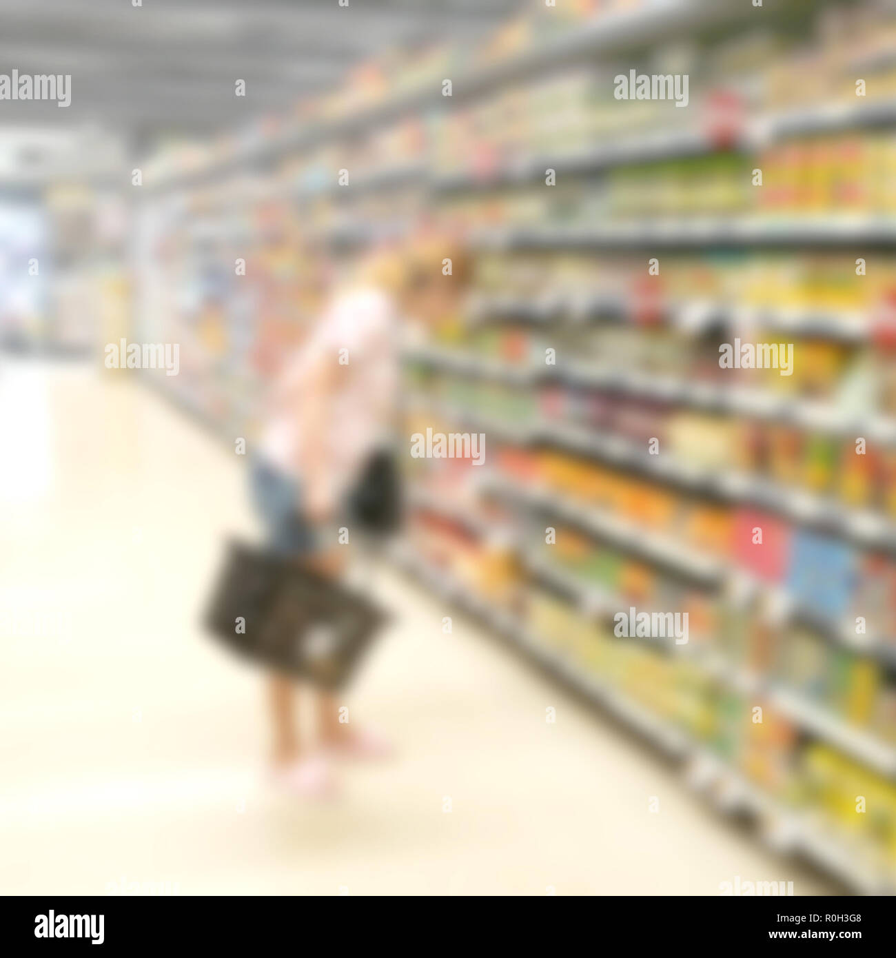 Abstract blur of aisle in supermarket with customers and department ...