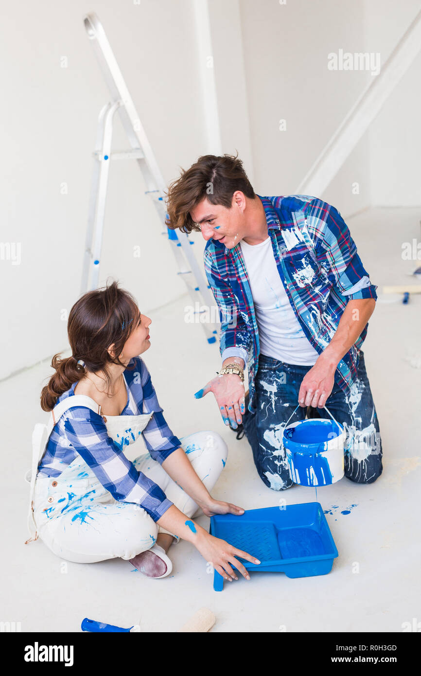 Repair, color, people concept - couple going to paint the wall, they ...