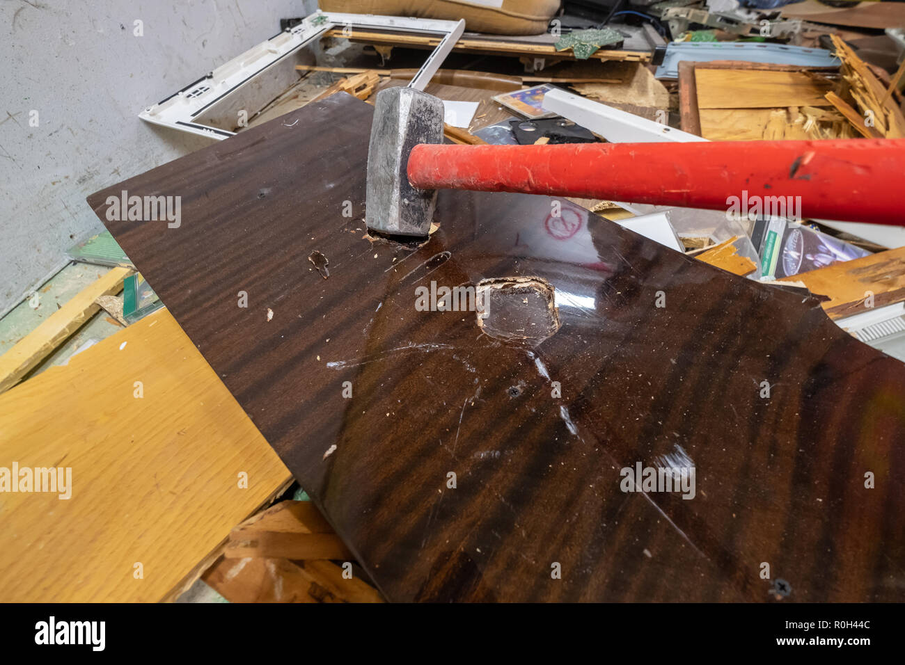 Sledgehammer destroys furniture close-up Stock Photo - Alamy