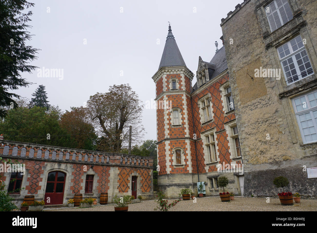 Side view of an old stone and red brick castle in a small provincial ...