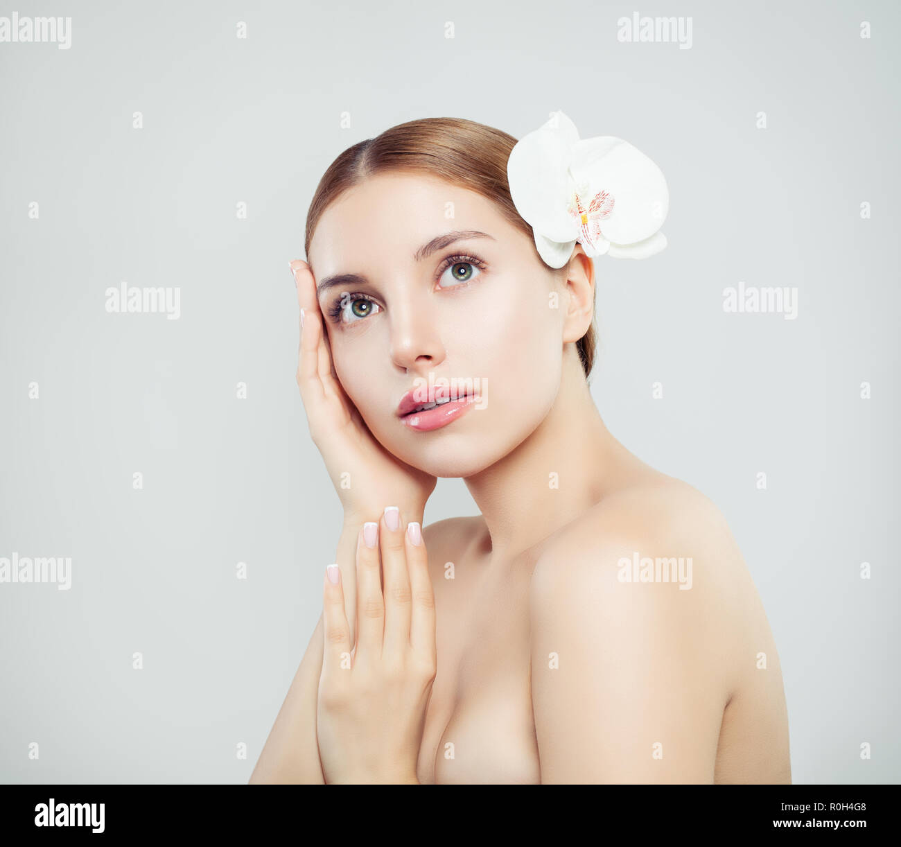 Beautiful Female Face With Healthy Skin And White Orchid Flower Stock