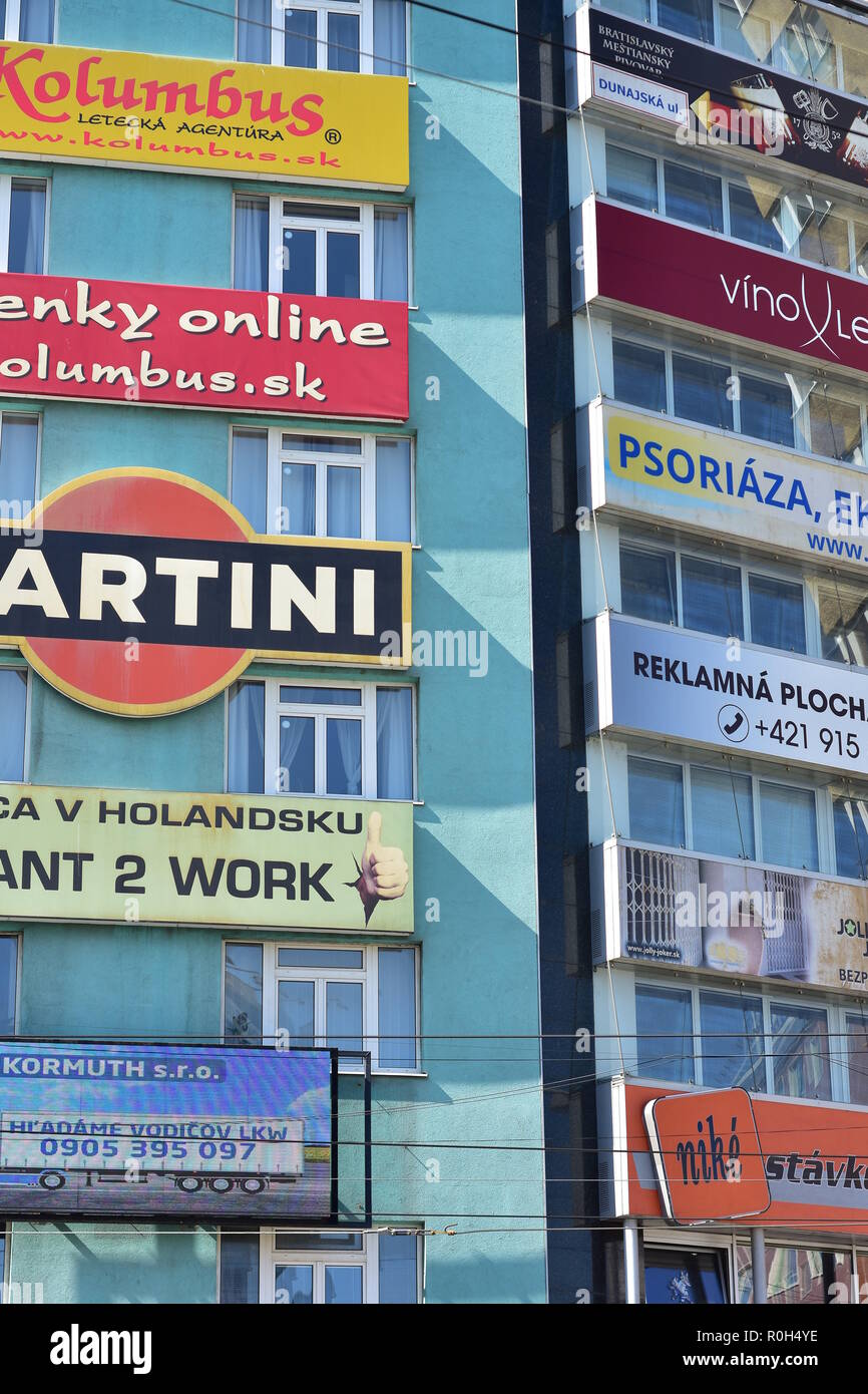 Colorful commercial advertisement boards on facade of apartment ...