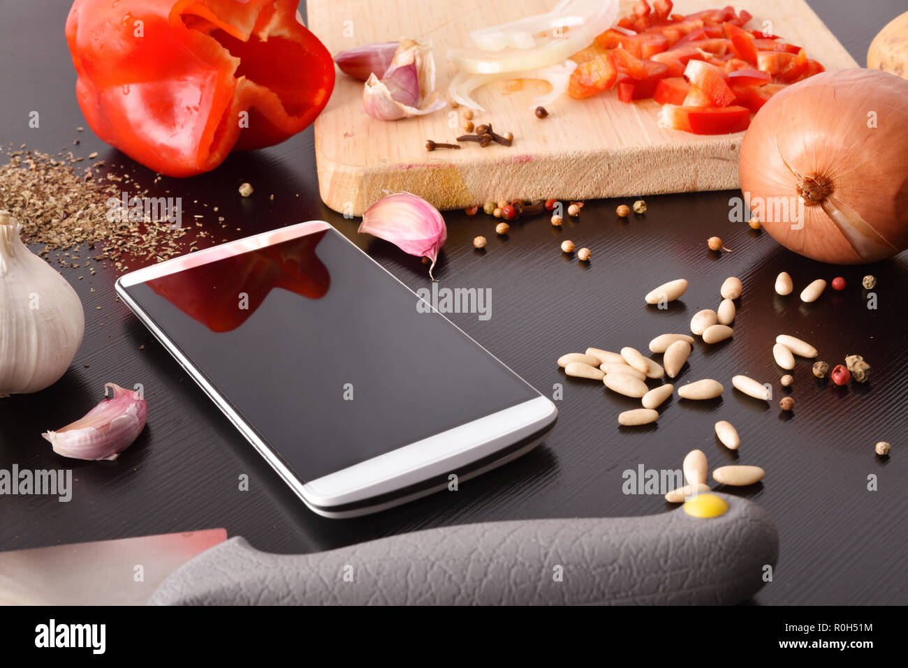 Preparation of vegetables on black wooden table with white mobile ...