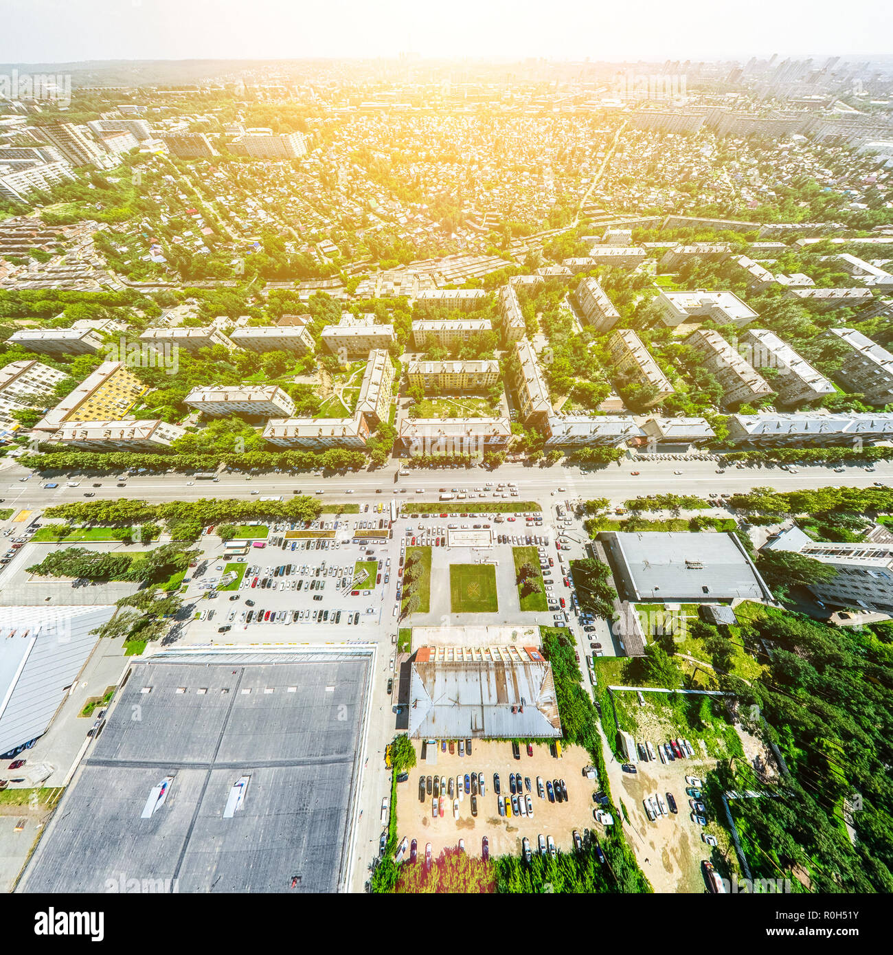 Aerial city view with crossroads and roads, houses, buildings, parks ...
