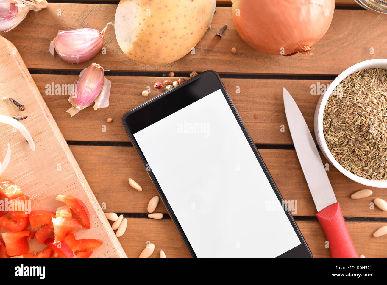Preparation of vegetables on wooden table with black mobile. Concept of ...
