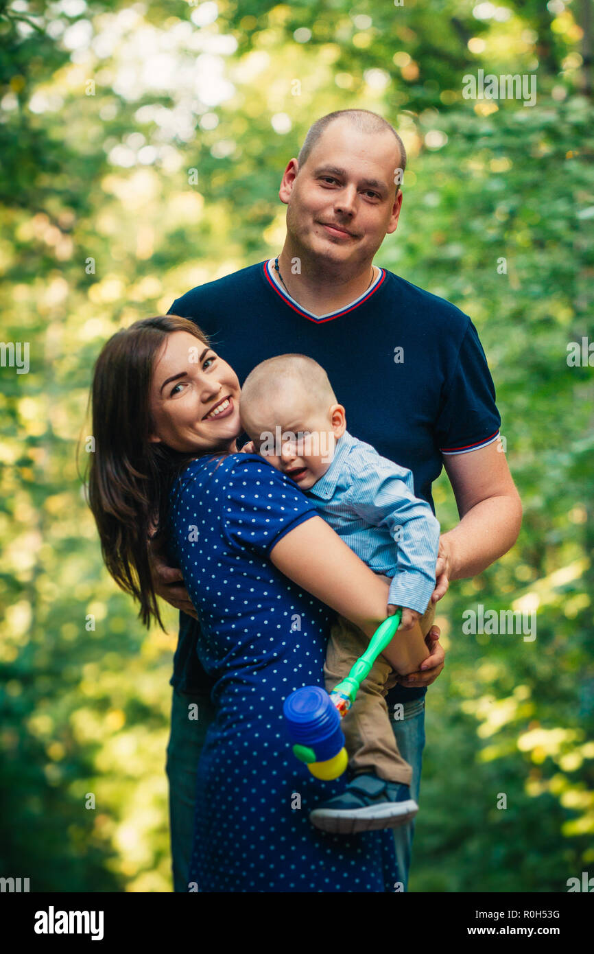 happy family with son on background forest Stock Photo - Alamy