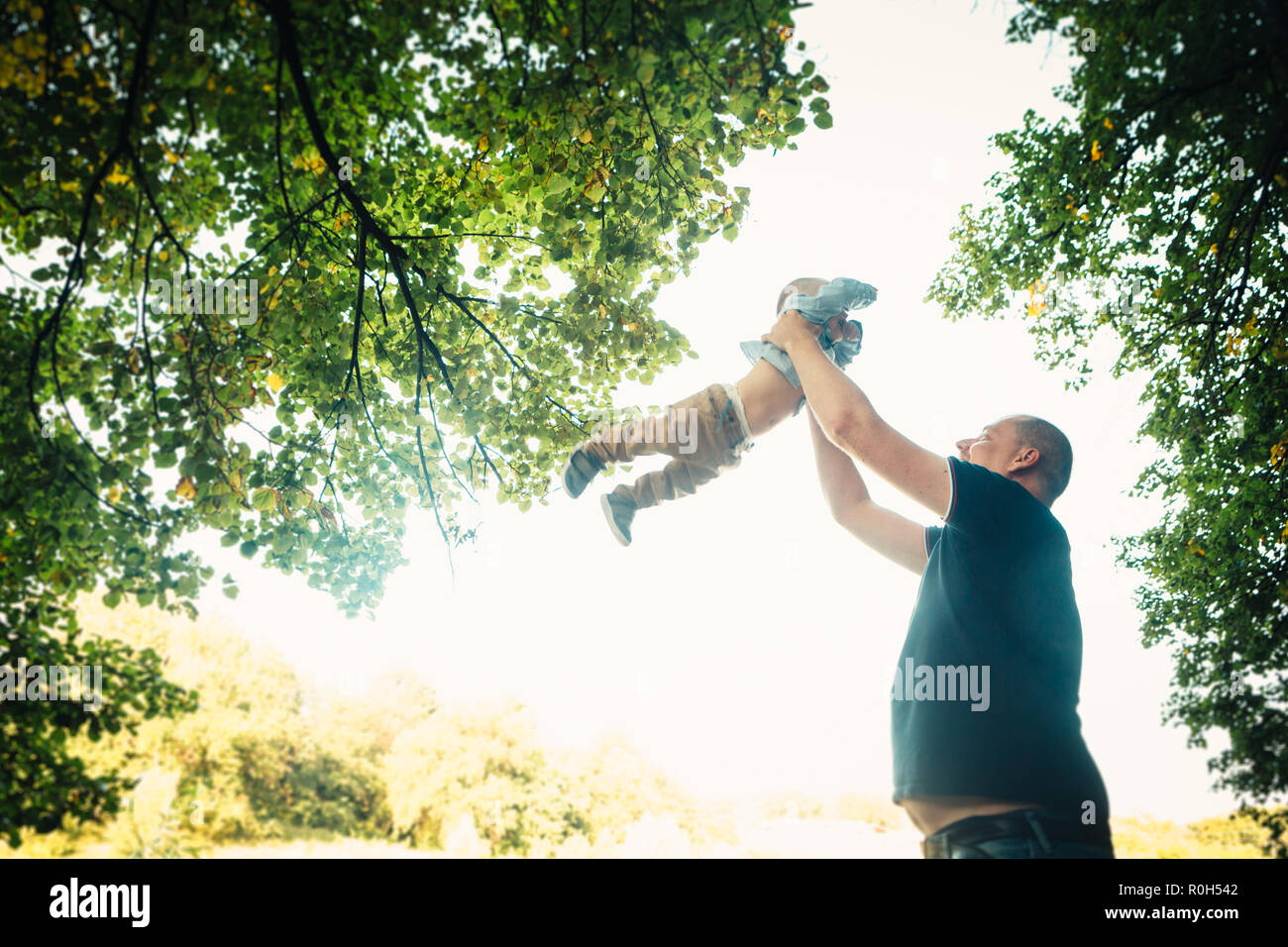 happy dad and baby on nature background Stock Photo - Alamy