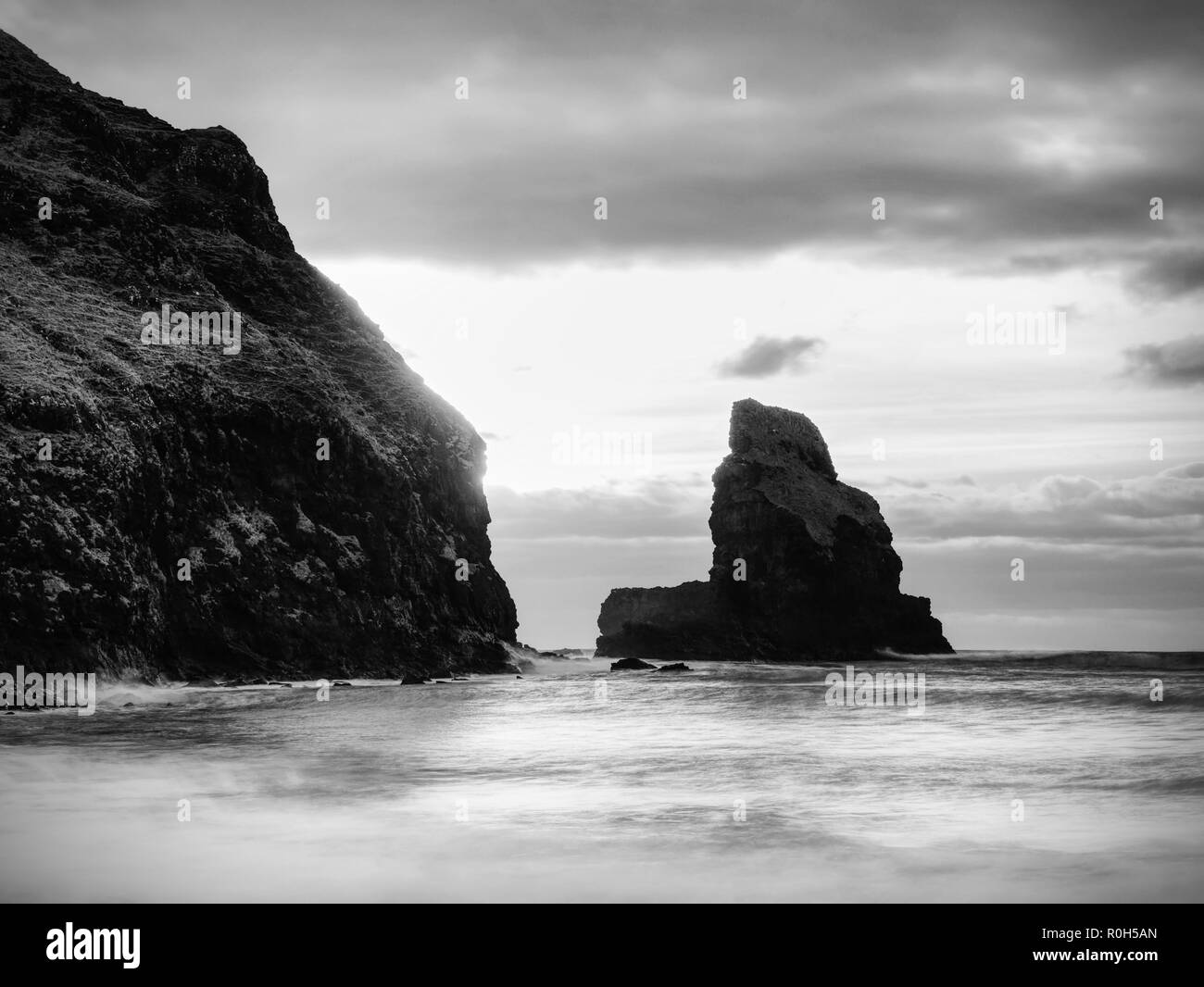Blue atmosphere in windless evening at sea. Big rounded boulders ...