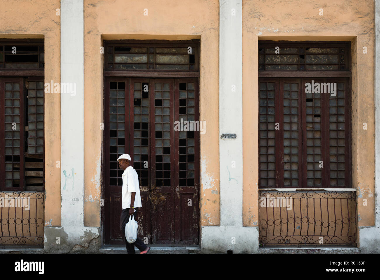 Man walking past building hi-res stock photography and images - Alamy