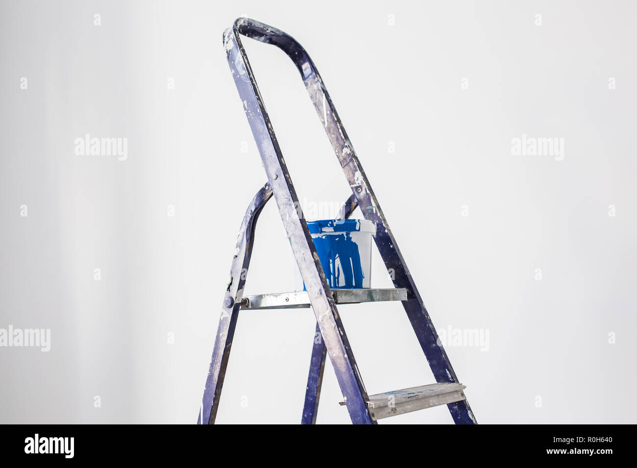 Renovation, redecoration and repair concept - Ladder with a container ...