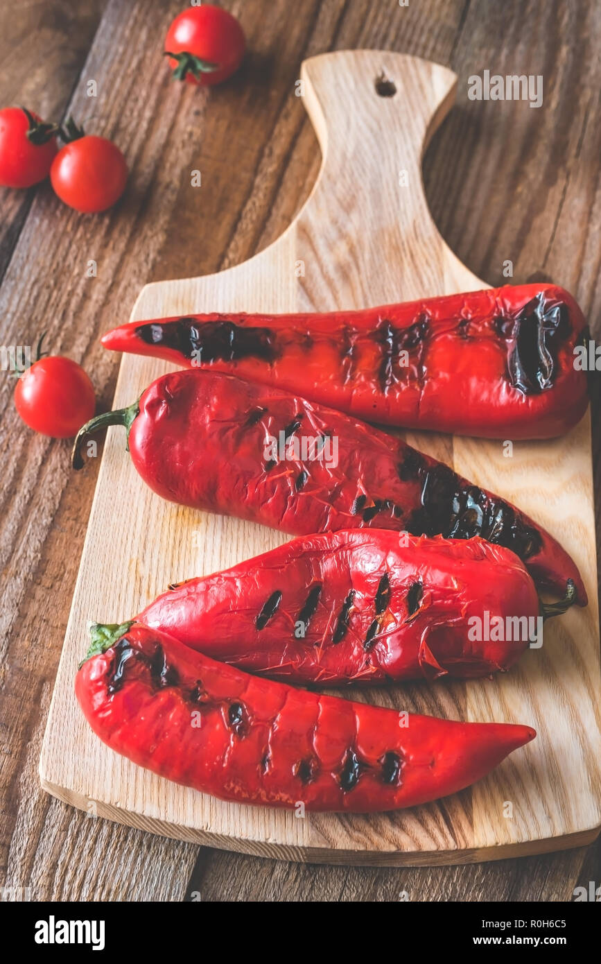 Grilled red peppers on the wooden board Stock Photo - Alamy