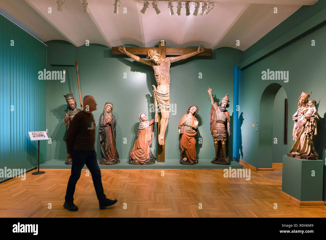 Wroclaw museum Poland,a tourist walks past a 1420 medieval crucifixion ...