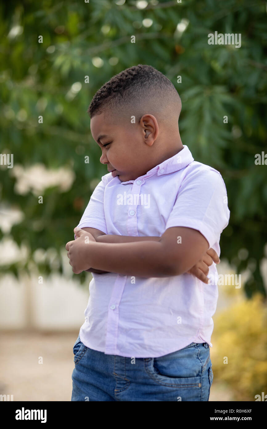 Angry latin child in a day in the park Stock Photo - Alamy