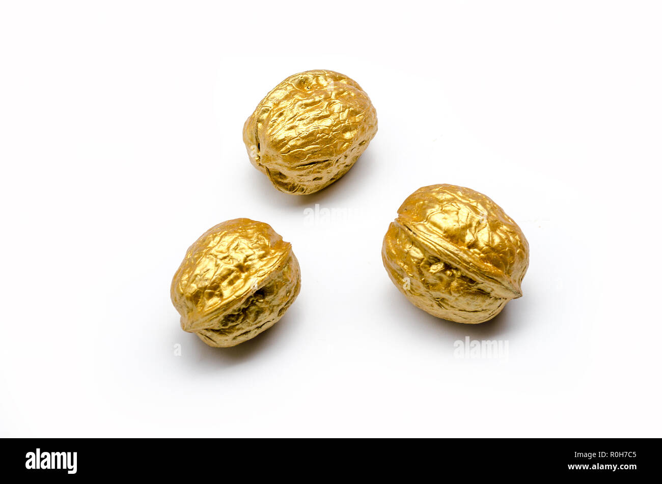 three golden walnuts on a white background, isolated Stock Photo - Alamy
