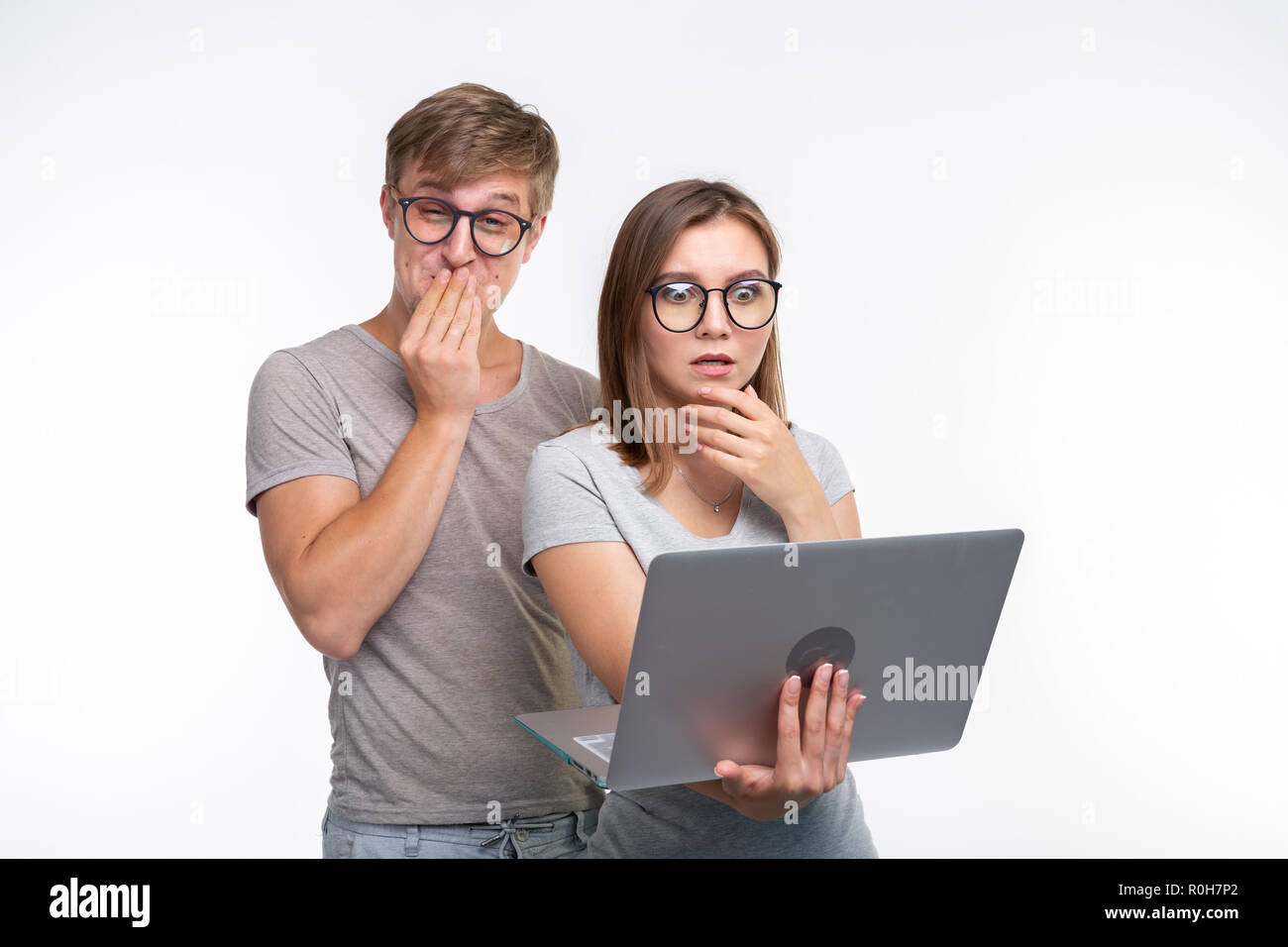 Nerds, study, people concept-a couple of people look at the netbook and ...