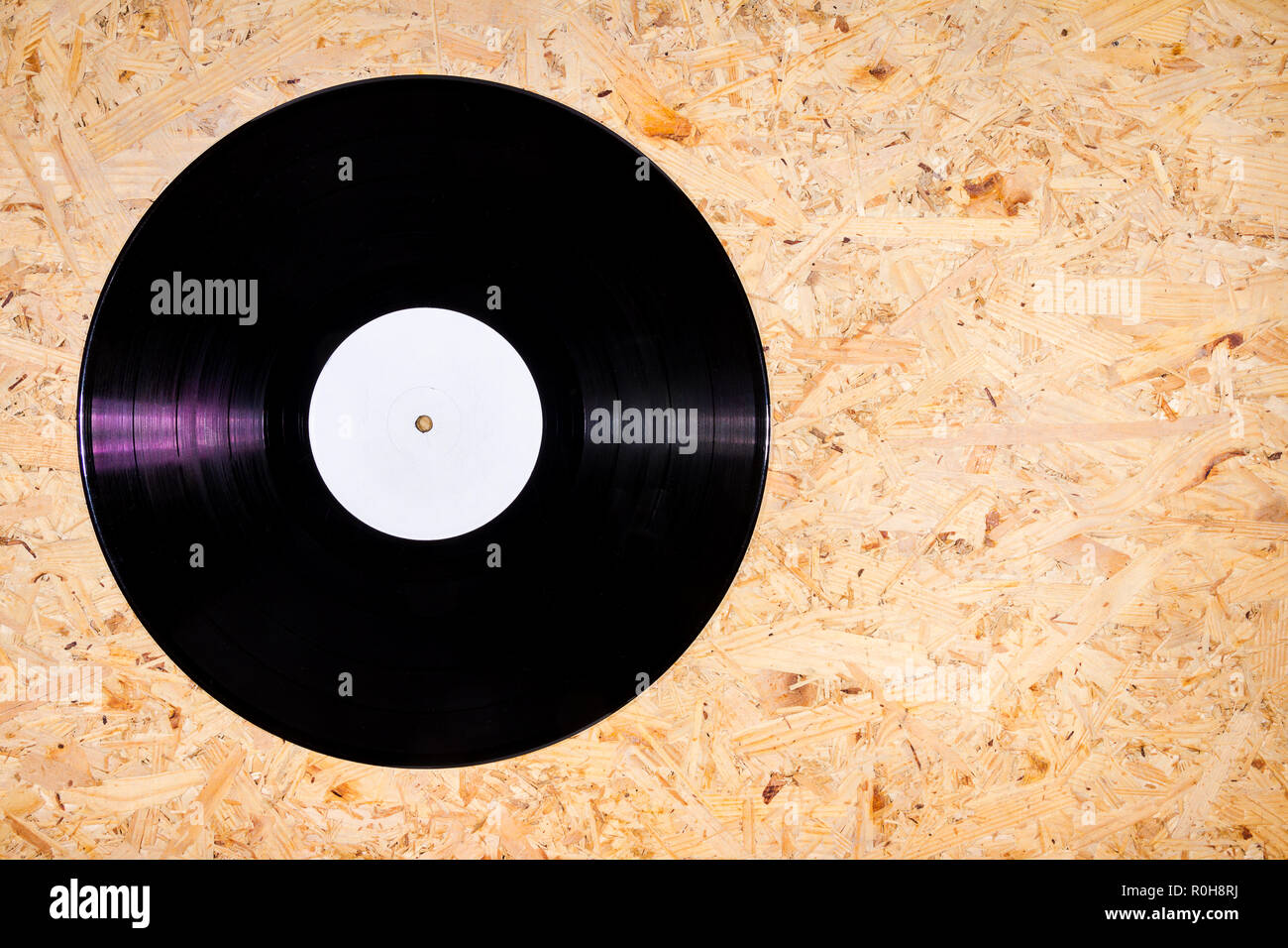 Black color vinyl record with white label on plywood background Stock ...