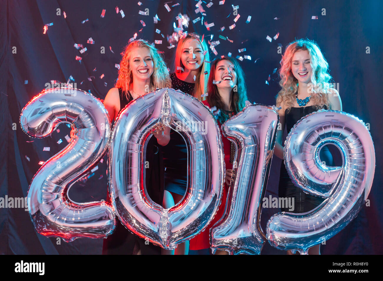 New Year party concept. Group of young women holding silver colored ...