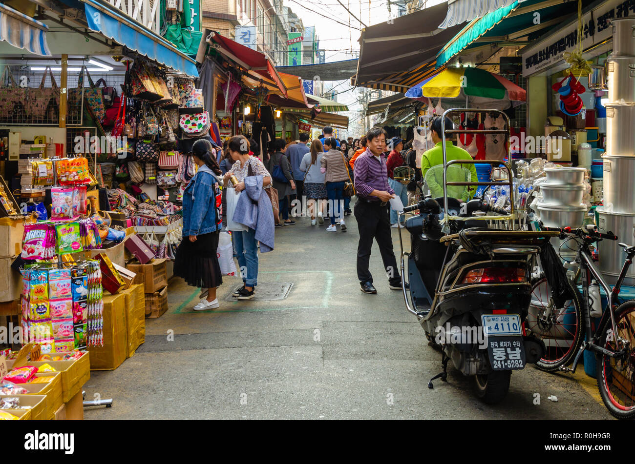Busy street market scene in Busan, South Korea. Street is full or ...