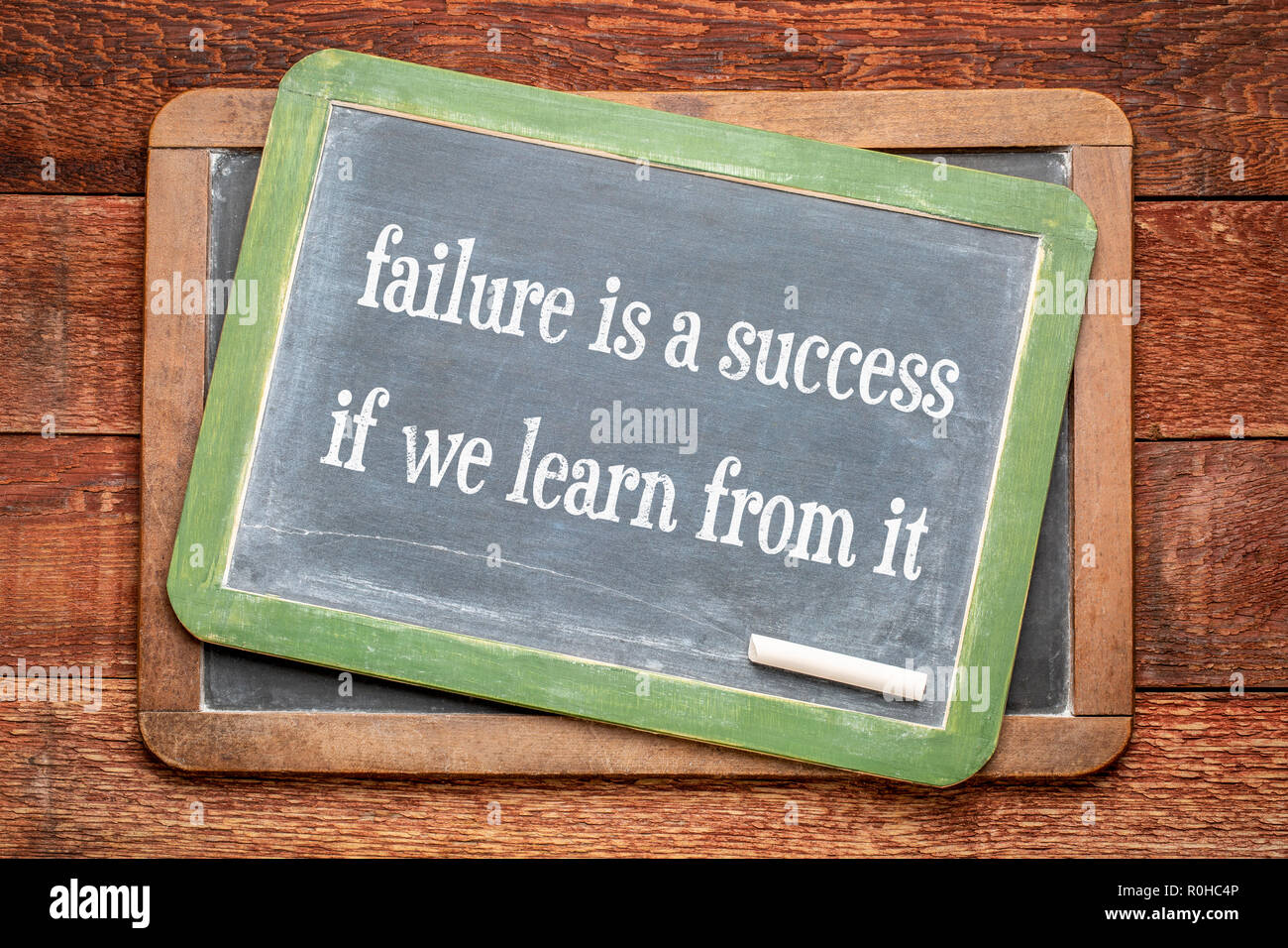 Failure is a success if we learn from it - white chalk text on a slate ...