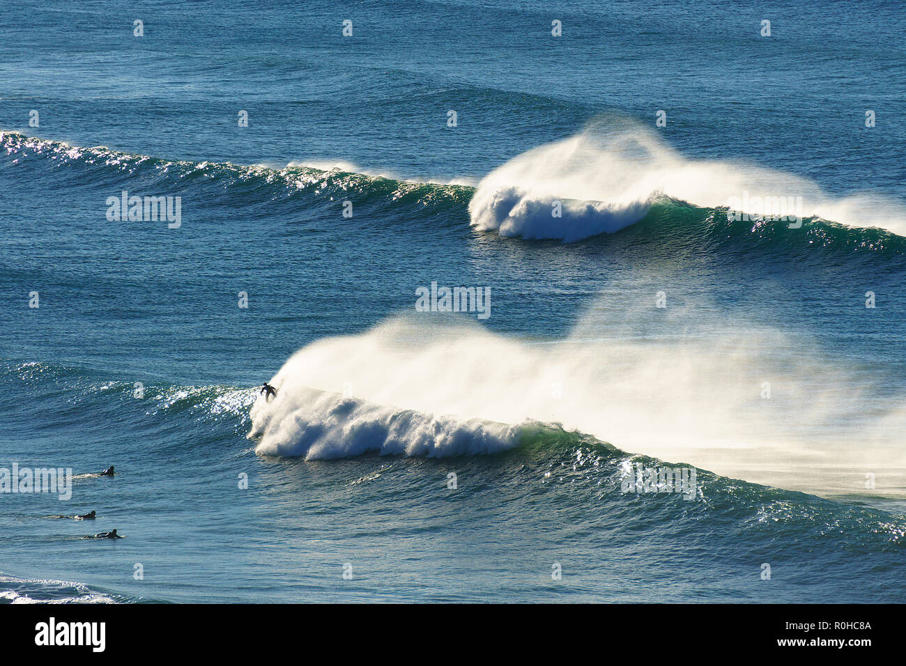 waves spraying and surfers on the sea Stock Photo - Alamy