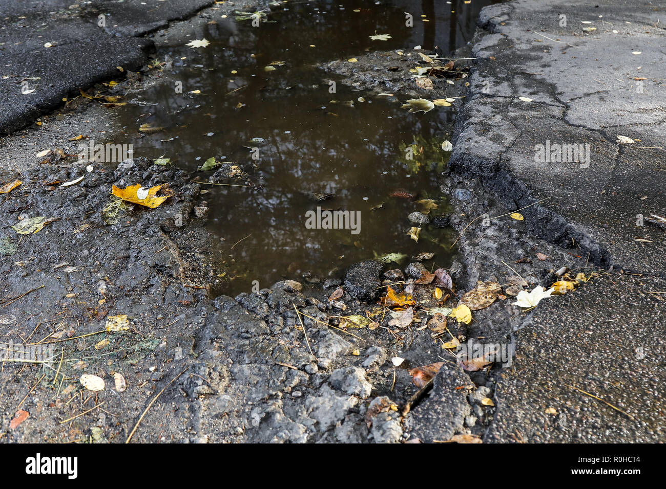 large pit with stones on the asphalt road Stock Photo - Alamy