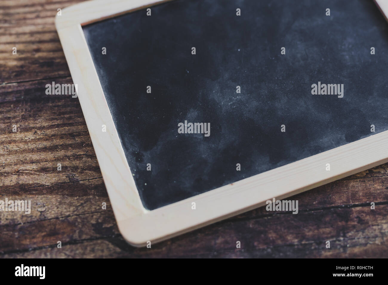 small vintage chalk blackboard on rustic wooden table, concept of ...