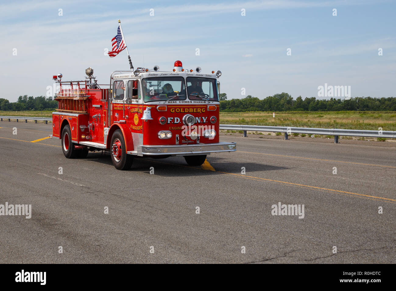 Classic red fire truck rushing on an empty road. Goldberg Fire ...