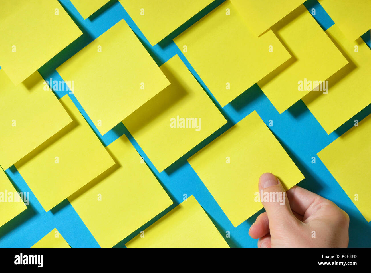 Hand holding post-it note on board Stock Photo - Alamy