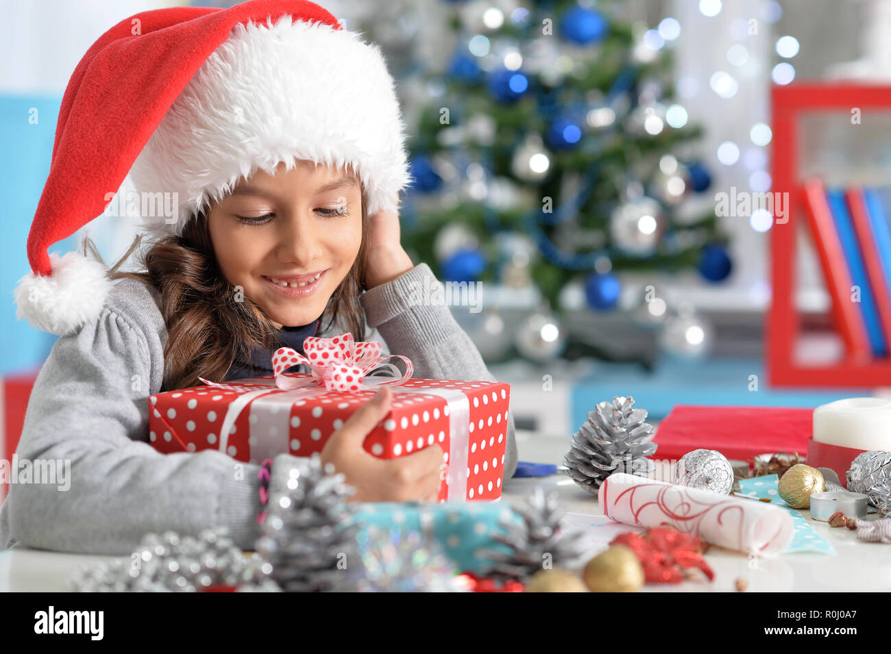 Portrait of cute child with Christmas present Stock Photo - Alamy
