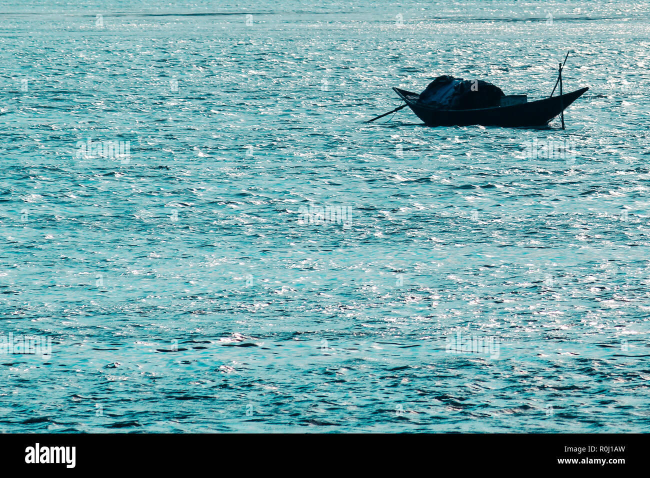 View of Clean flowing blue water surface with ripples and sunrays or ...